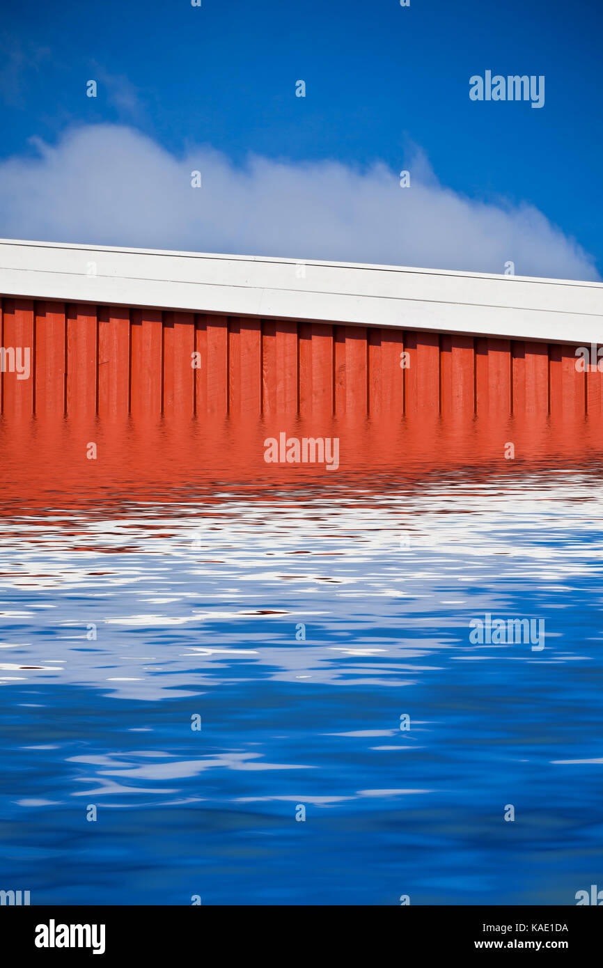 Bright Red Siding House in water flood. Blue sky background Stock Photo ...
