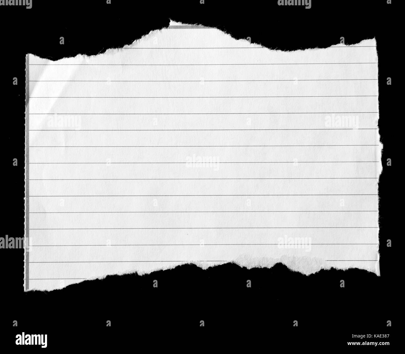 Piece of torn lined paper on black Stock Photo - Alamy