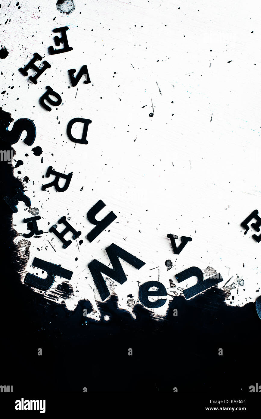 Scattered letters in blurring spilled ink. Creative writing concept ...
