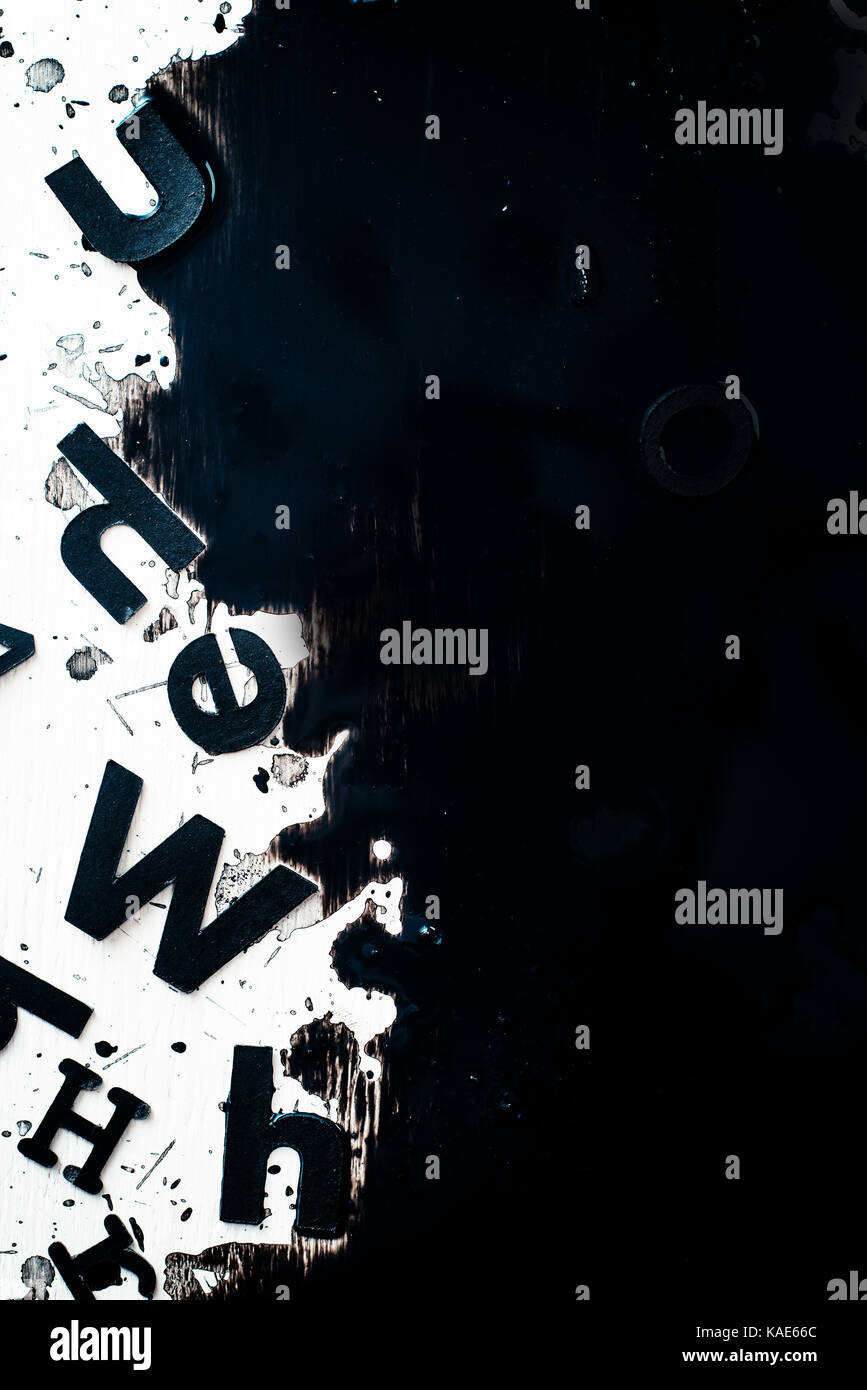 Scattered letters in blurring spilled ink. Creative writing concept ...