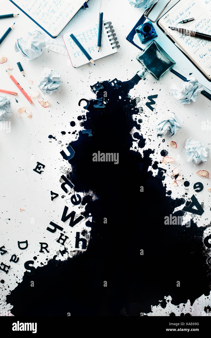 Writer workplace with spilled ink, crumpled paper, scattered letters ...
