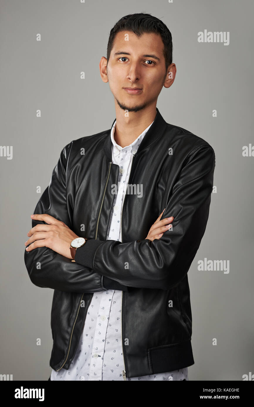 Confident young latino man with crossed arms Stock Photo - Alamy