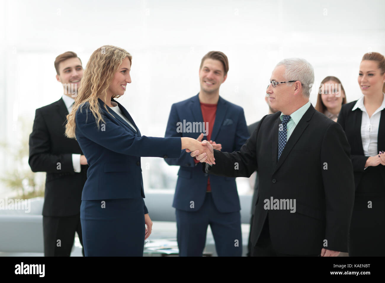 handshake serious businessman and business woman Stock Photo - Alamy