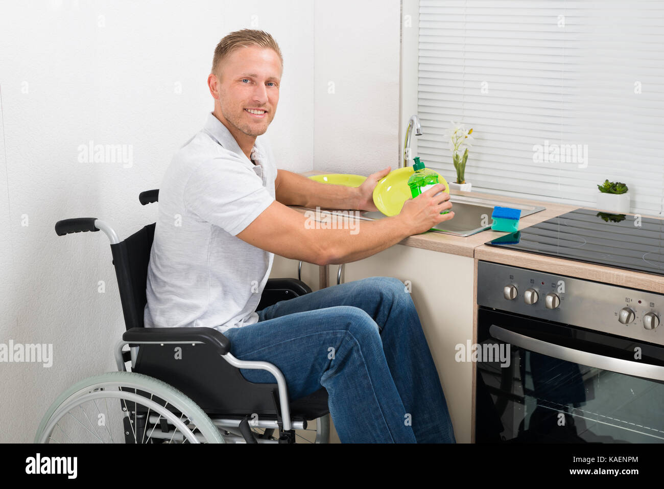 Young Happy Disabled Man On Wheelchair Washing Dishes Stock Photo - Alamy