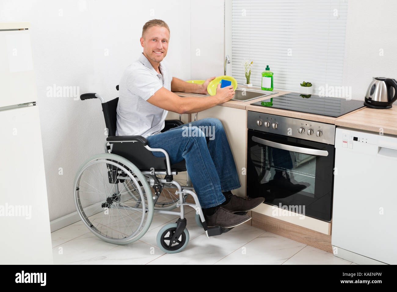 Young Happy Disabled Man On Wheelchair Washing Dishes Stock Photo - Alamy