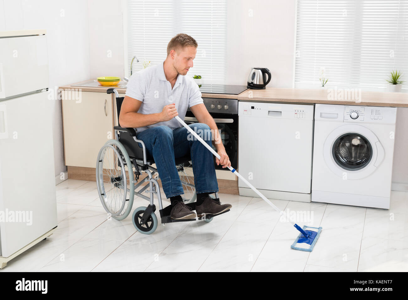 Disabled man on wheelchair cleaning hi-res stock photography and images ...