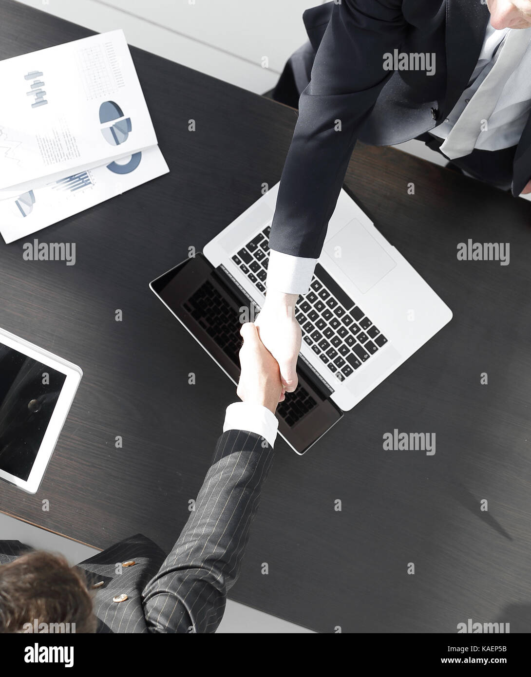 handshake of business partners above the Desk Stock Photo - Alamy