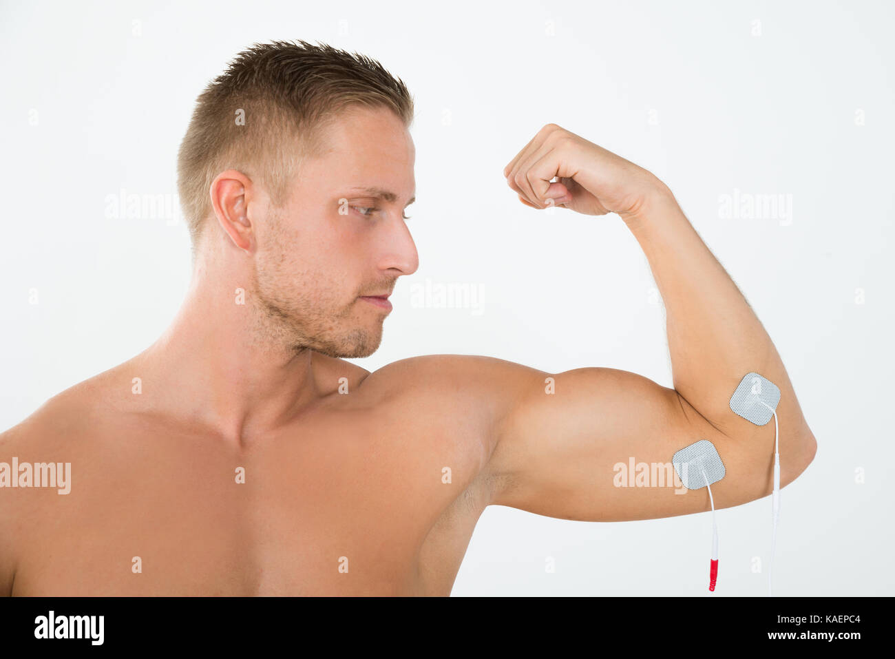Portrait Of Young Man Having Electrotherapy Of Arm Muscle Stock Photo ...