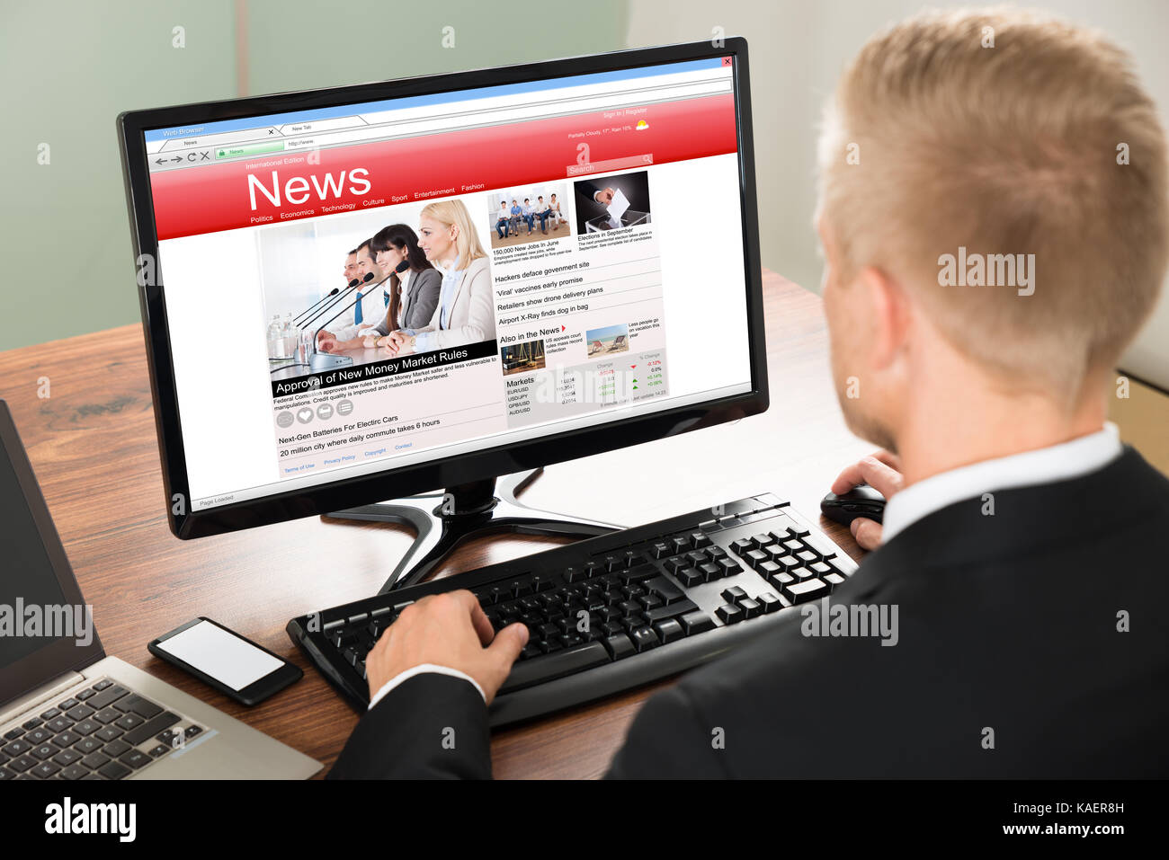 Close-up Of A Businessman Reading News On Computer At Office Stock ...