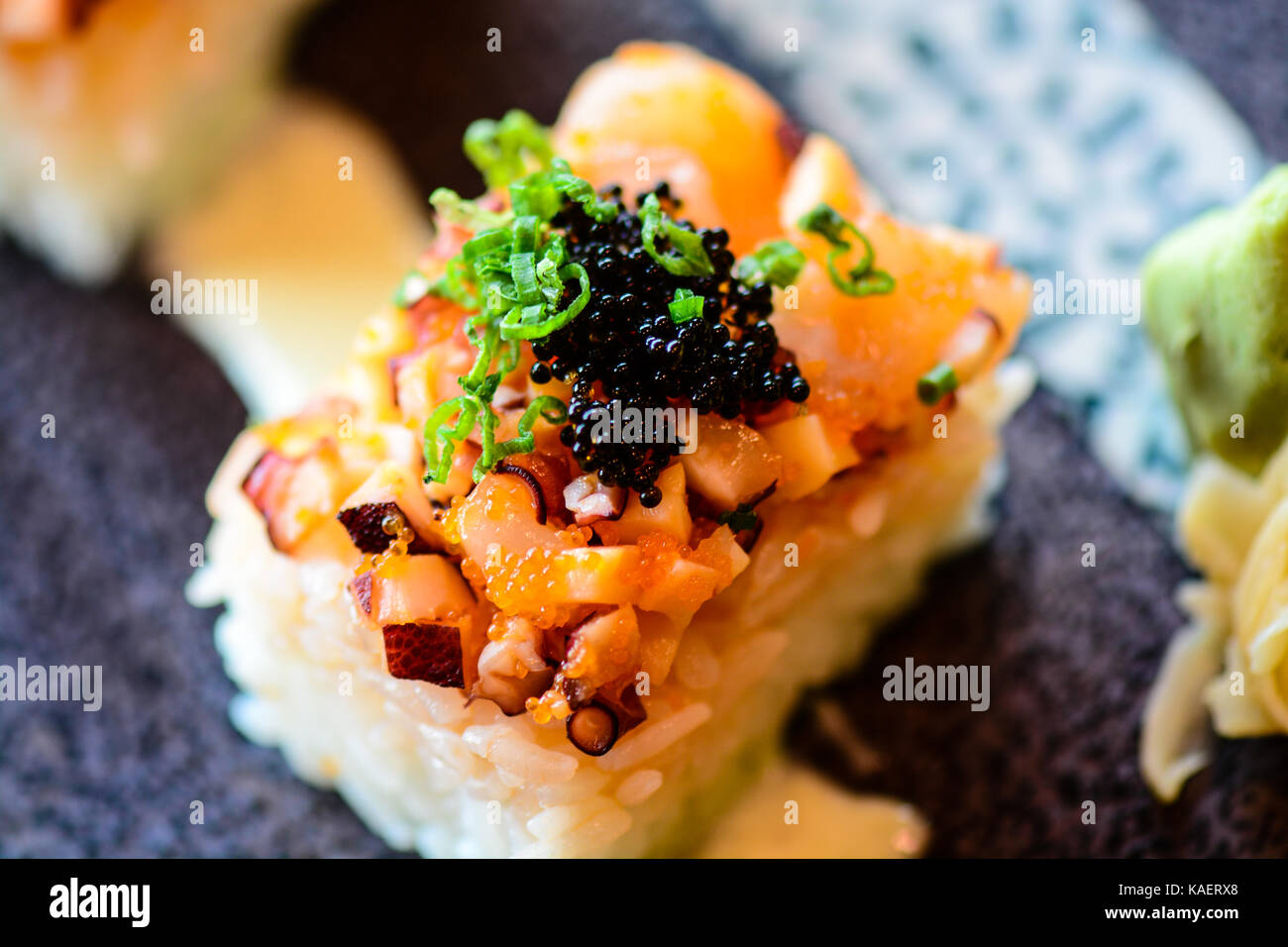 Rice Cube Sushi topped with spicy tako (octopus Stock Photo - Alamy