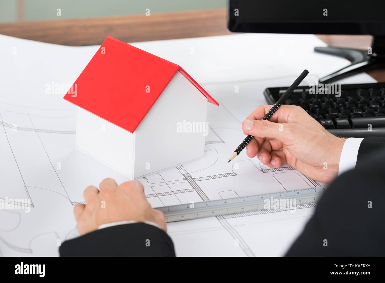 Close-up Of Architect With House Model Making Blueprint Stock Photo - Alamy