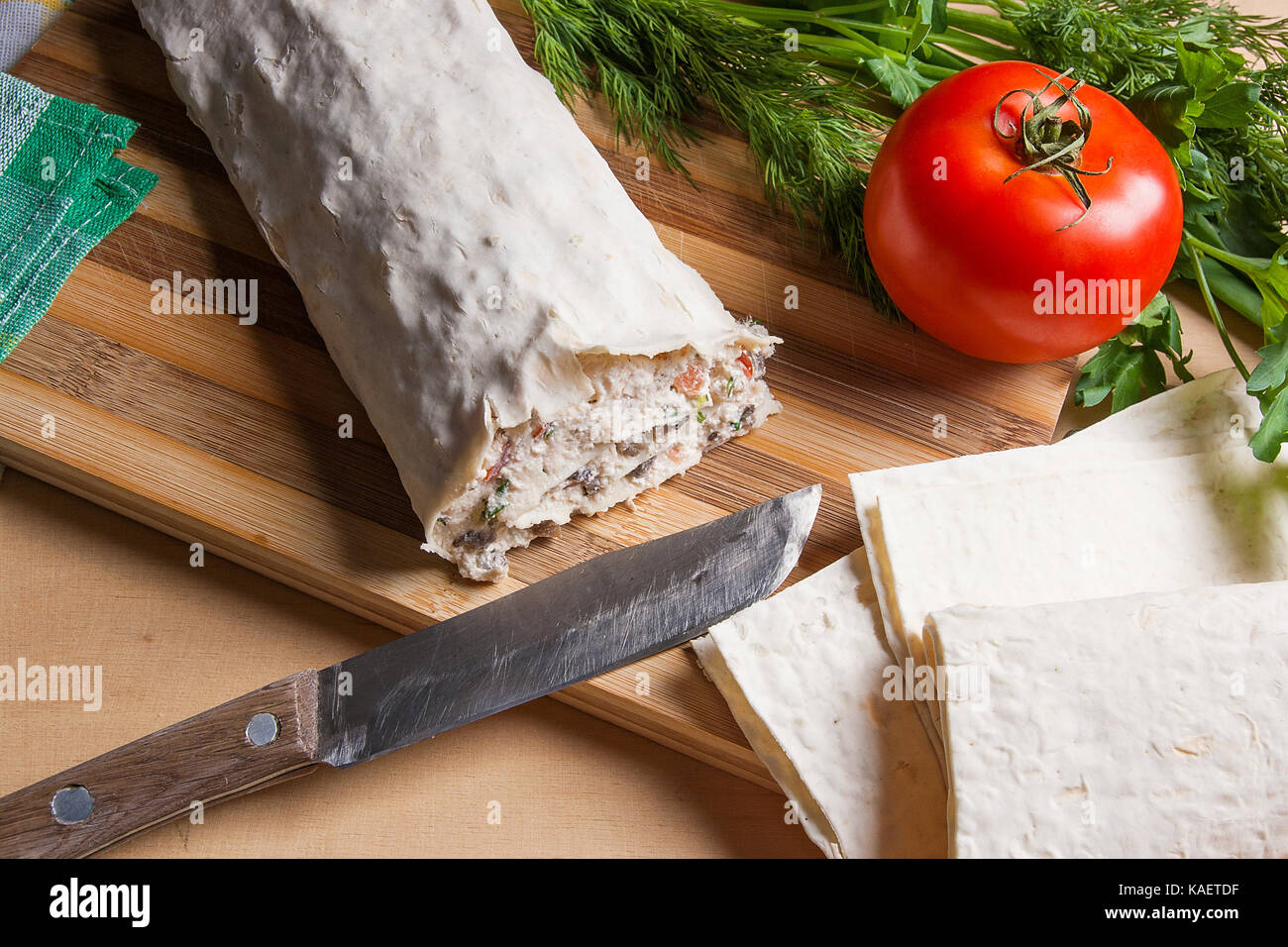 Thin Armenian pita bread or lavash wrapped tomatoes, cottage cheese or ...
