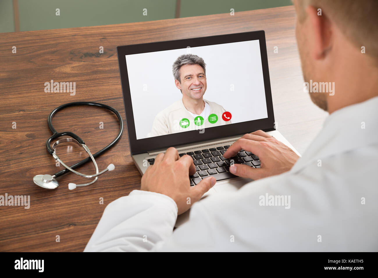 Close-up Of Doctor Talking To Male Patient Through Video Chat On Laptop ...