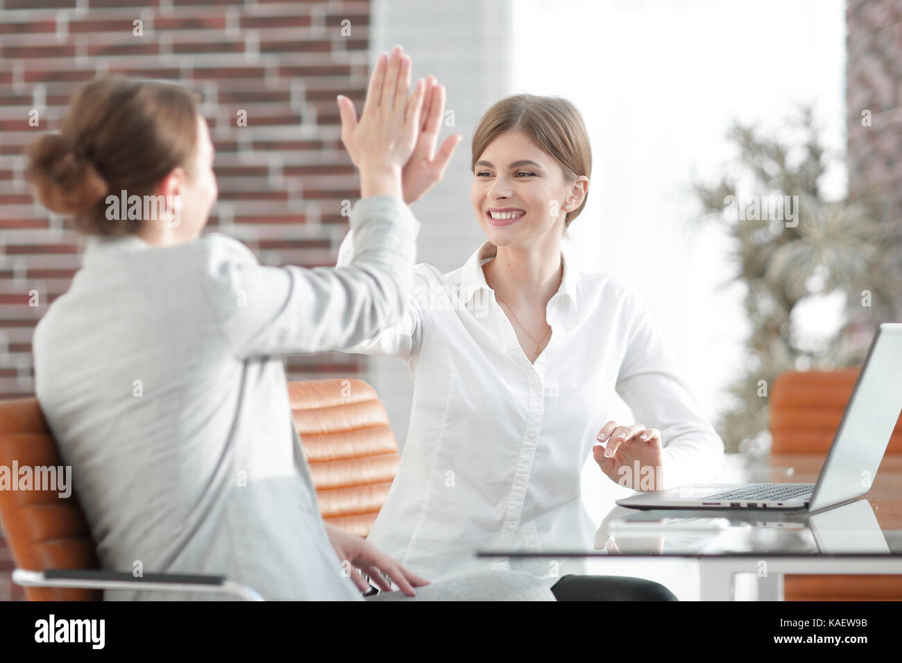 members of the business team giving each other a high five Stock Photo ...