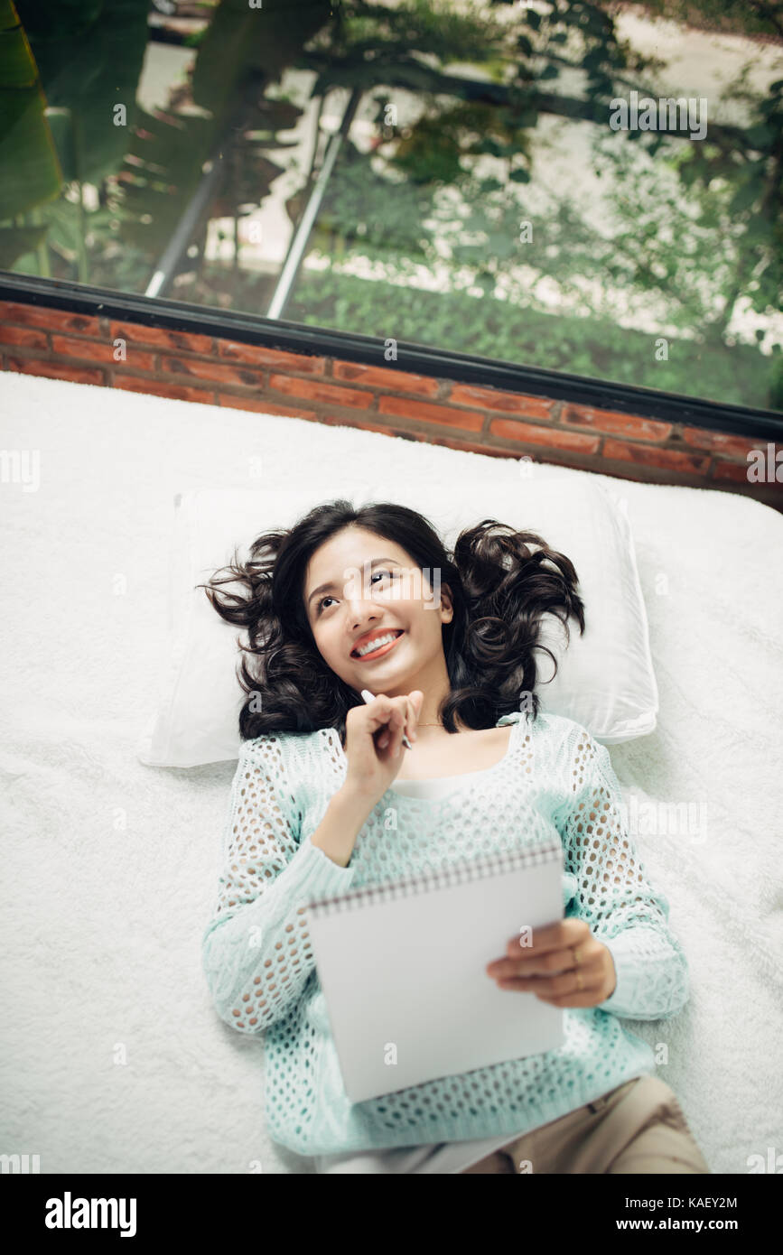 Author, Typewriter, Journalist. Intelligent woman lying on bed and ...