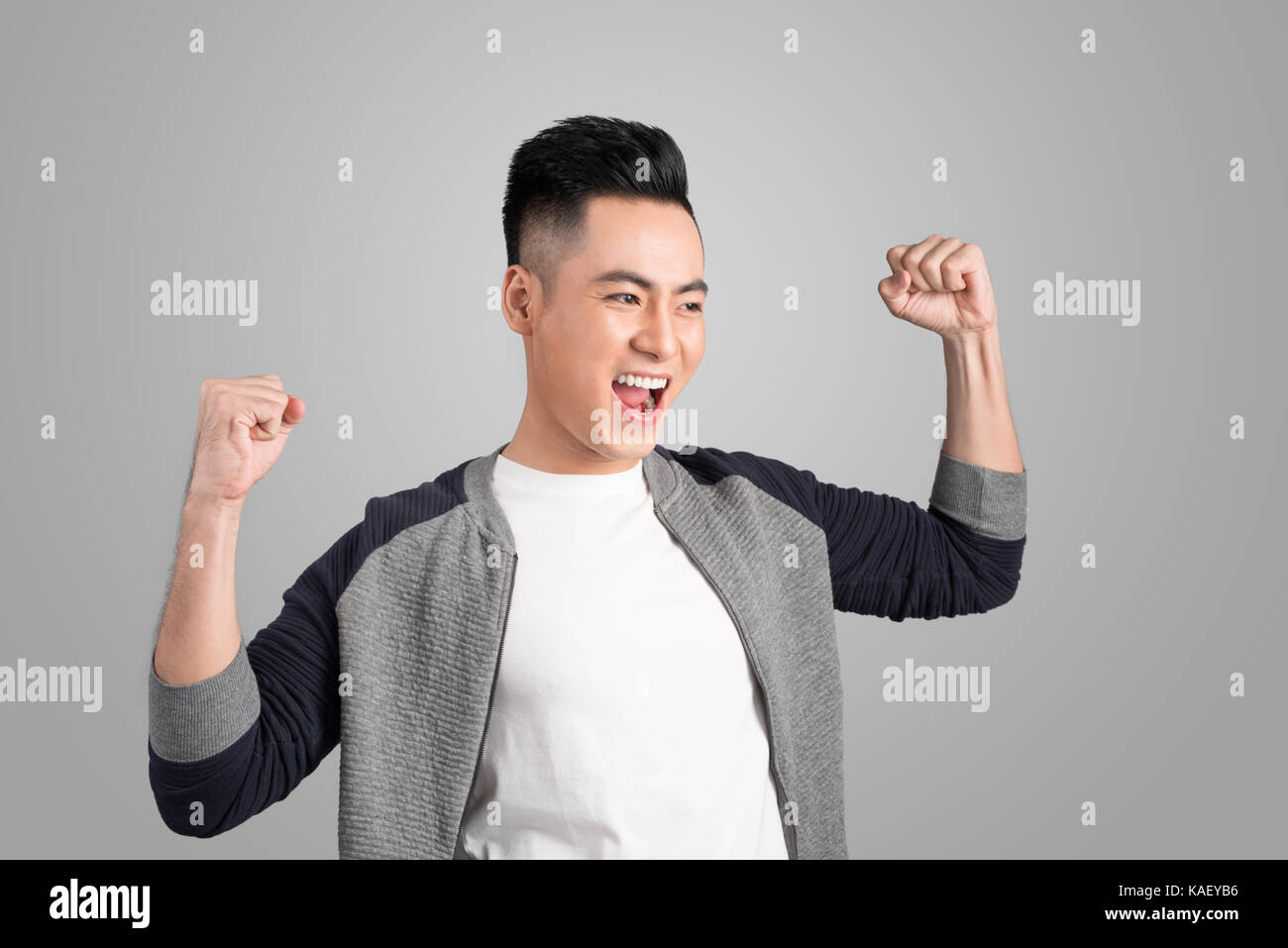 A portrait of happy excited young asian man with success positive ...