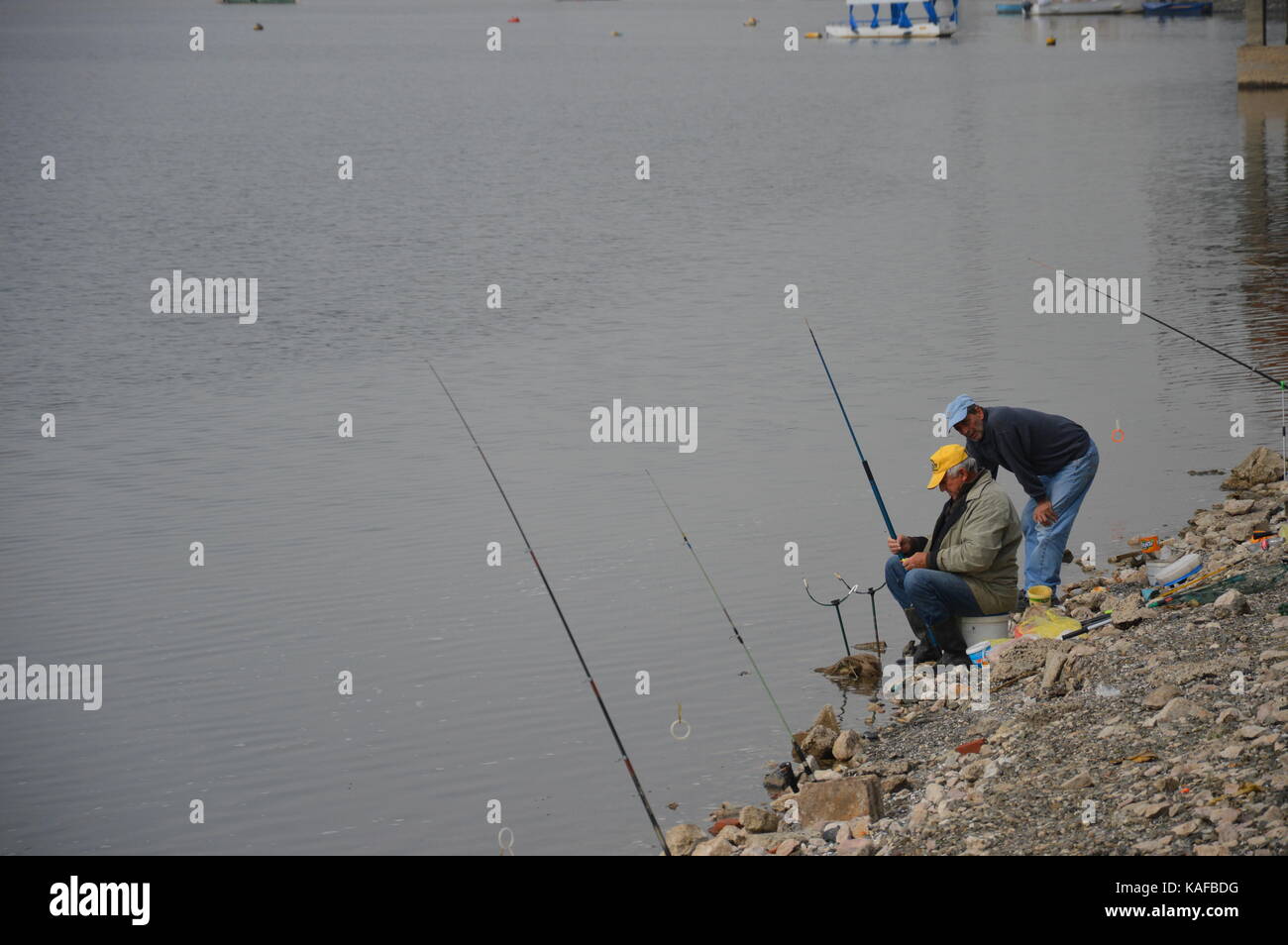 Big lake Modrac and two fishermen Stock Photo - Alamy