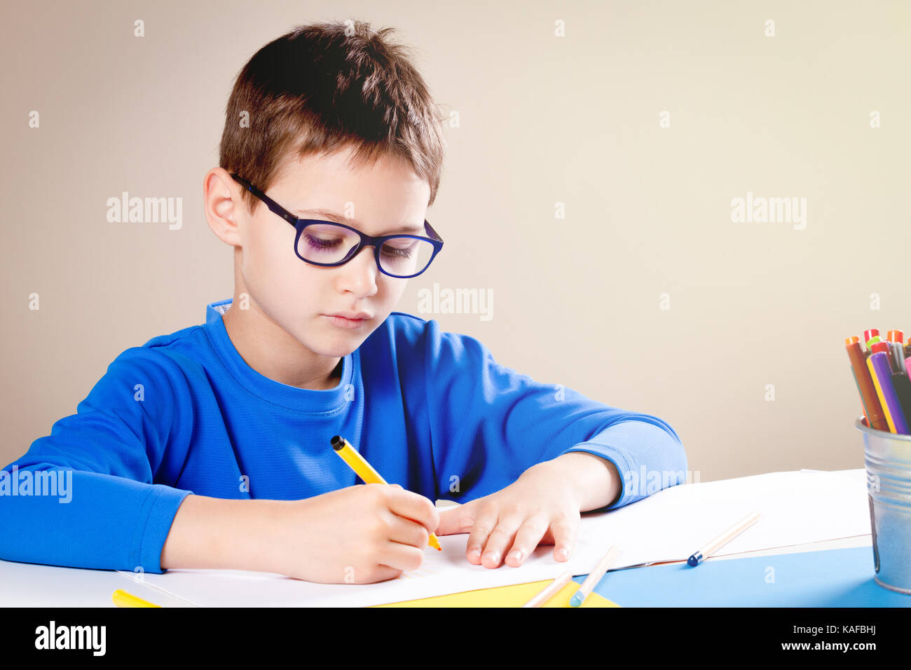 Little boy draws with color pencils and felt pens Stock Photo - Alamy