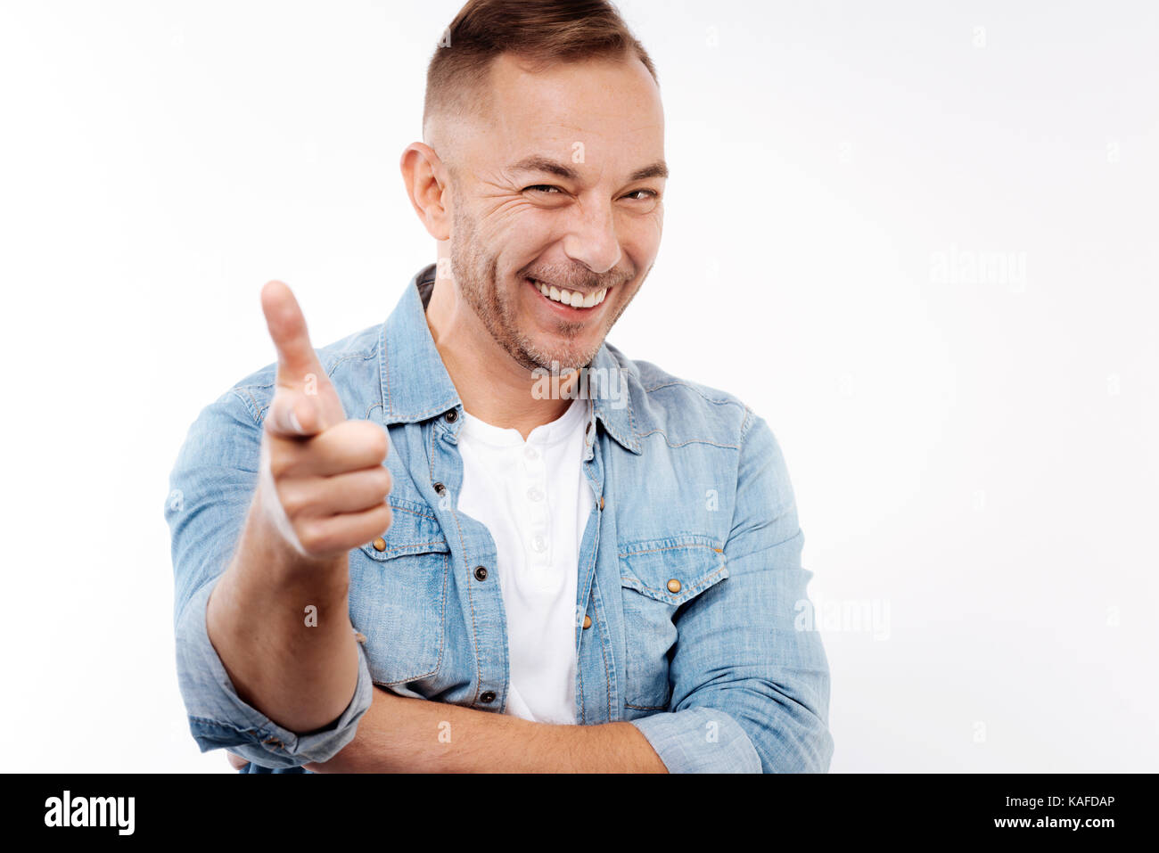 Handsome man smiling and pointing at camera with finger Stock Photo - Alamy