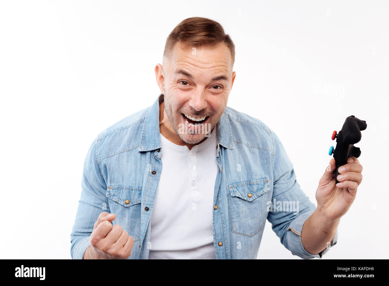 Overjoyed man being happy about victory in video game Stock Photo - Alamy
