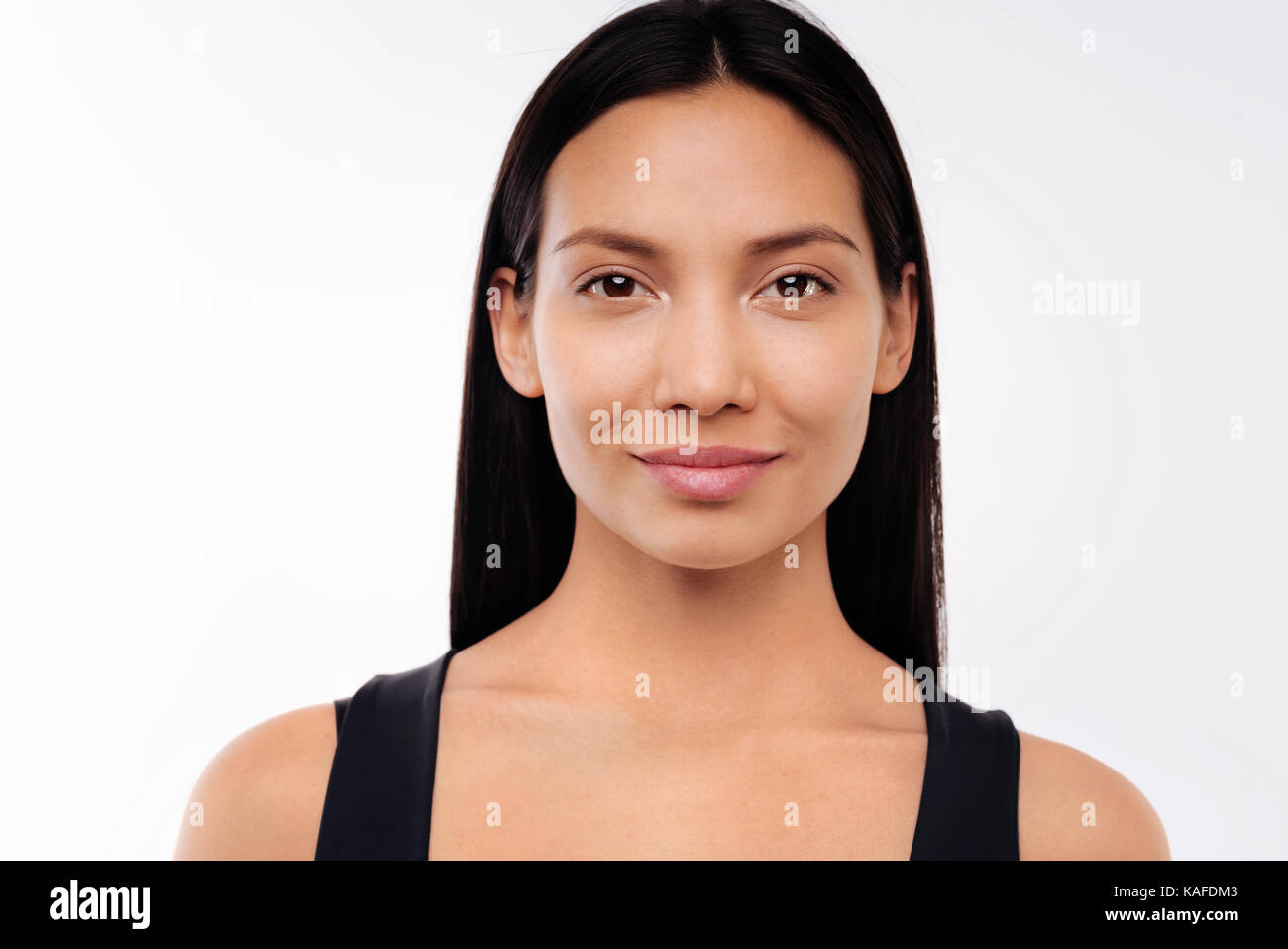 Portrait of beautiful black-haired woman posing on white background ...
