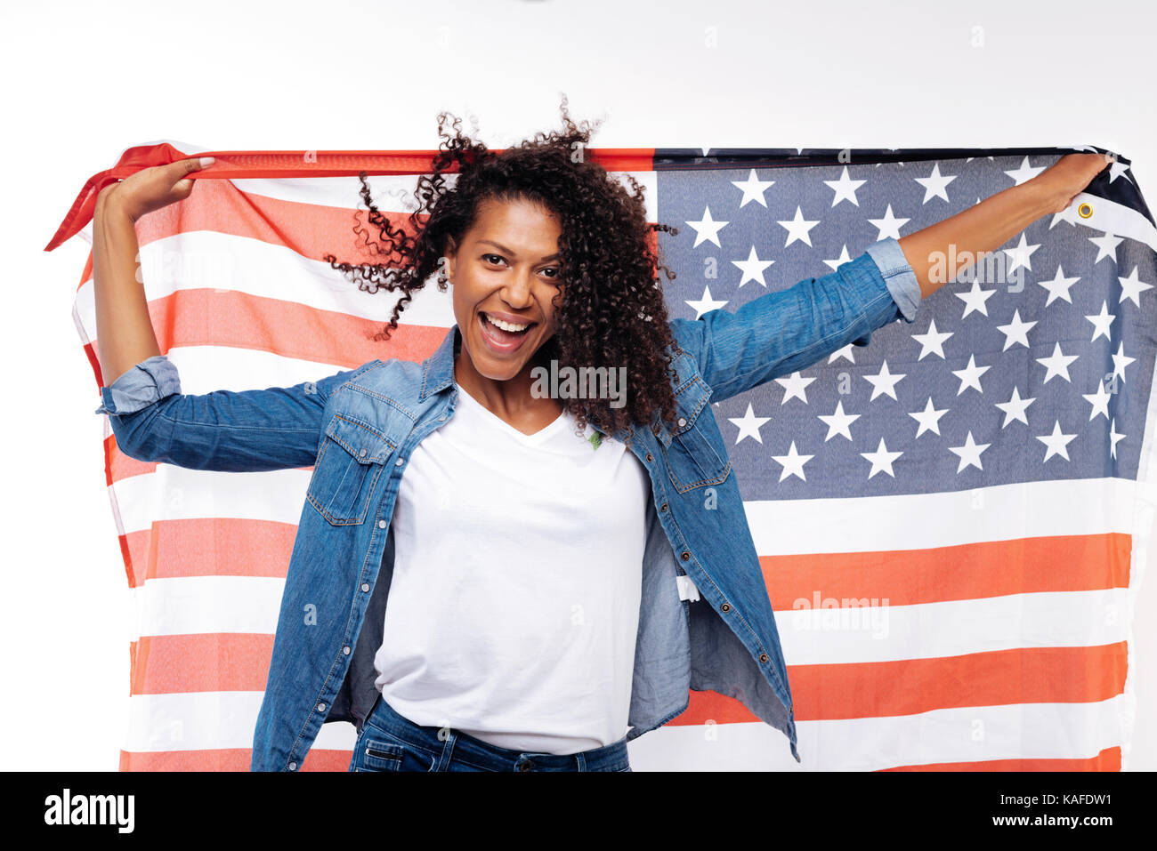 Cheerful woman posing with an American flag Stock Photo - Alamy