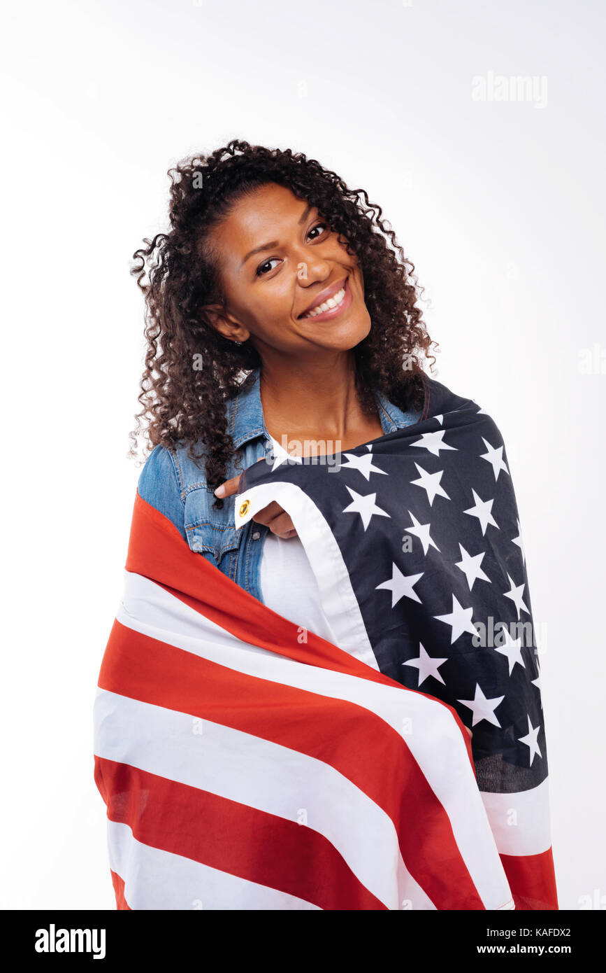 Curly brunette posing with American flag Stock Photo - Alamy