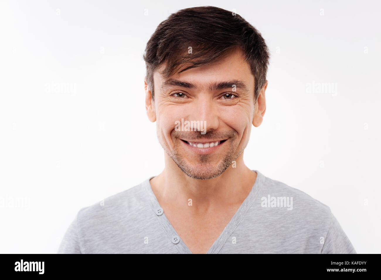 Pleasant cheerful man smiling at the camera Stock Photo - Alamy