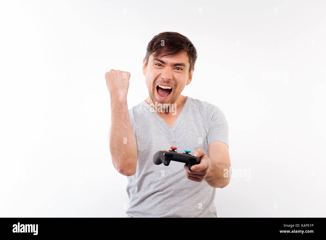 Happy man celebrating victory in video game Stock Photo - Alamy