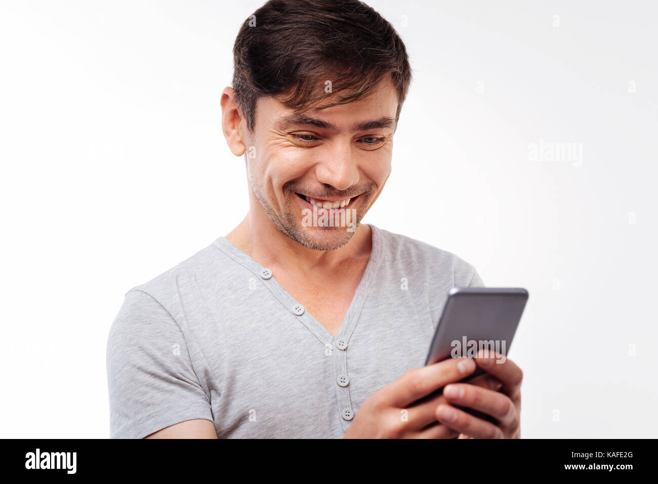 Happy handsome man reading text message with smile Stock Photo - Alamy