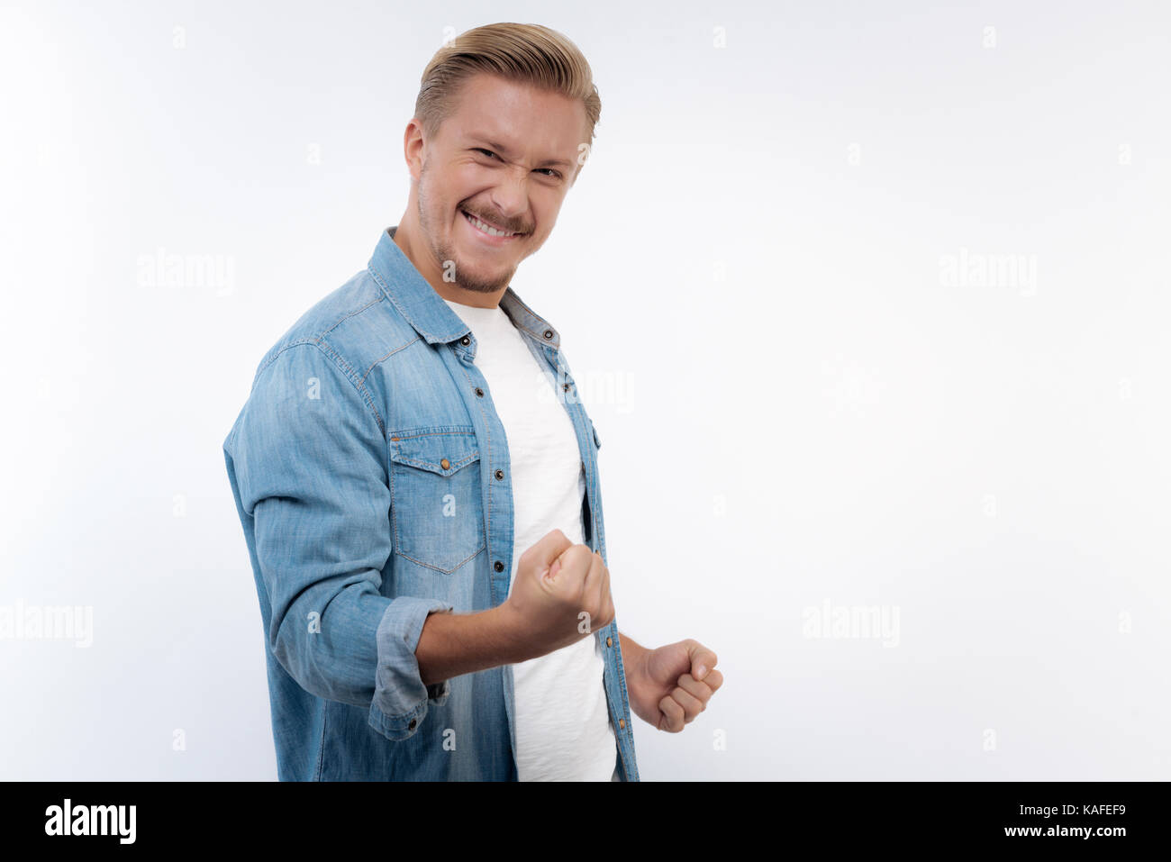 Cheerful young man celebrating his success Stock Photo - Alamy