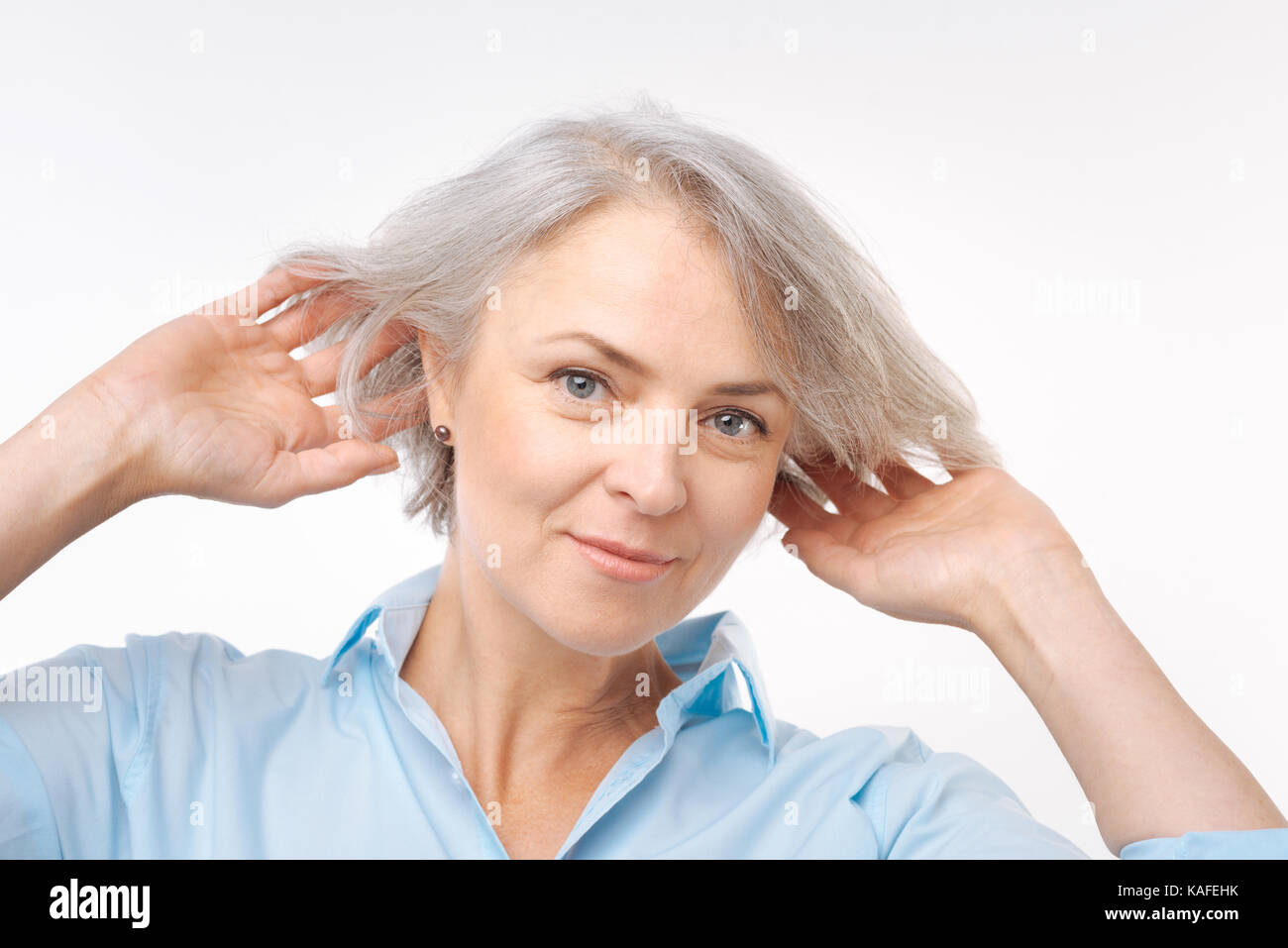 Charming woman lifting up her hair with hands Stock Photo - Alamy