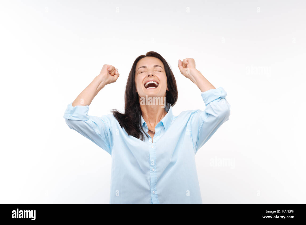 Beautiful woman raising her hands in gesture of happiness Stock Photo ...