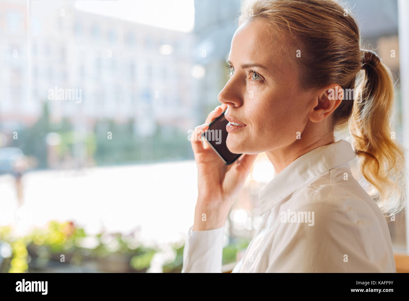 Beautiful woman making a phone call in cafe Stock Photo - Alamy