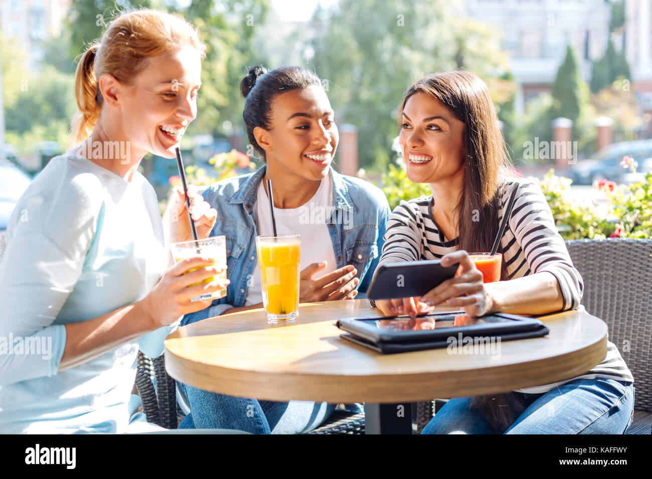 Three friends taking a selfie together in cafe Stock Photo - Alamy