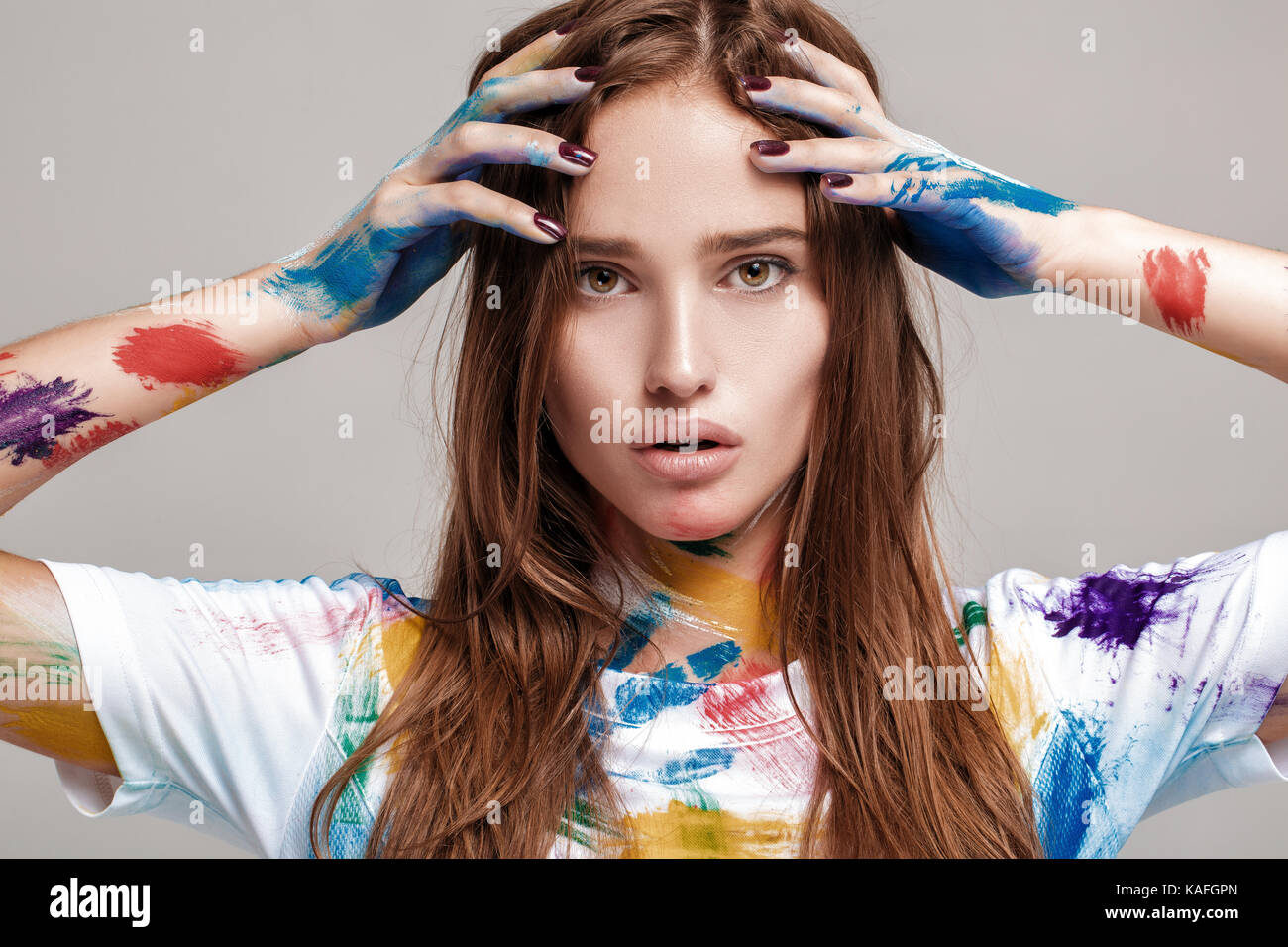 young woman smeared in multicolored paint Stock Photo - Alamy
