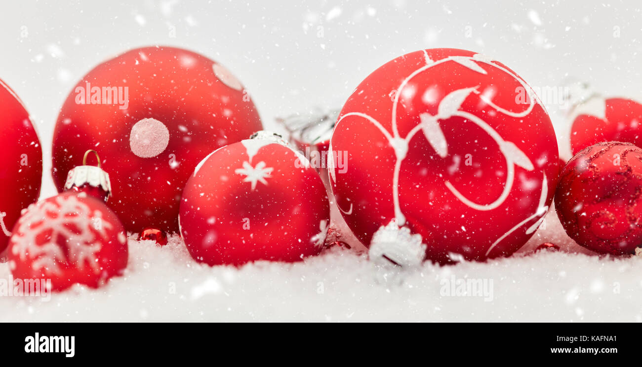 Snow and red christmas baubles as decoration for background Stock Photo ...