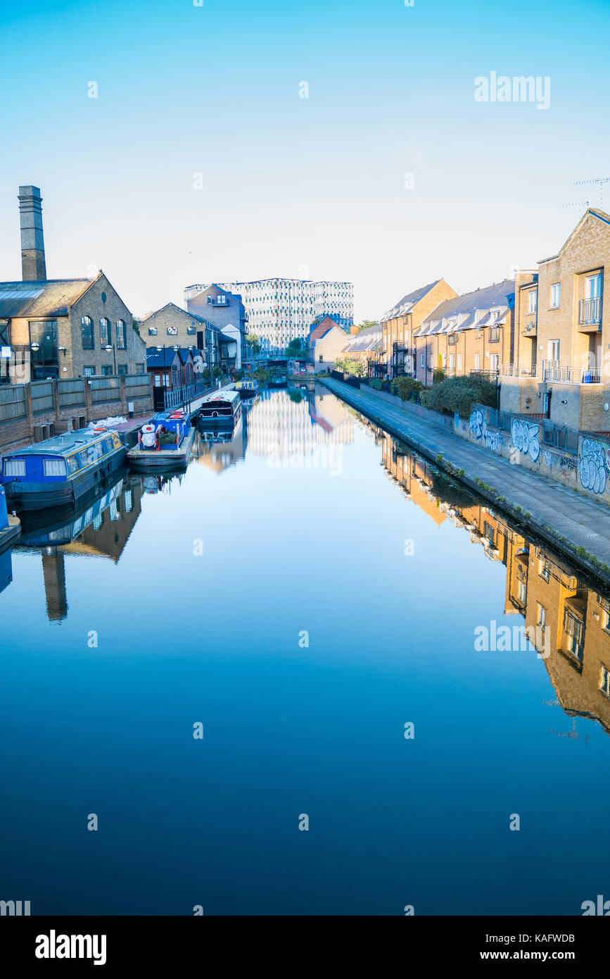Hertford Union Canal calm in eary moring light with house boats moored ...