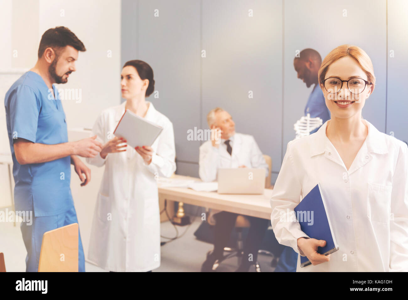Attractive female person standing on the foreground Stock Photo - Alamy
