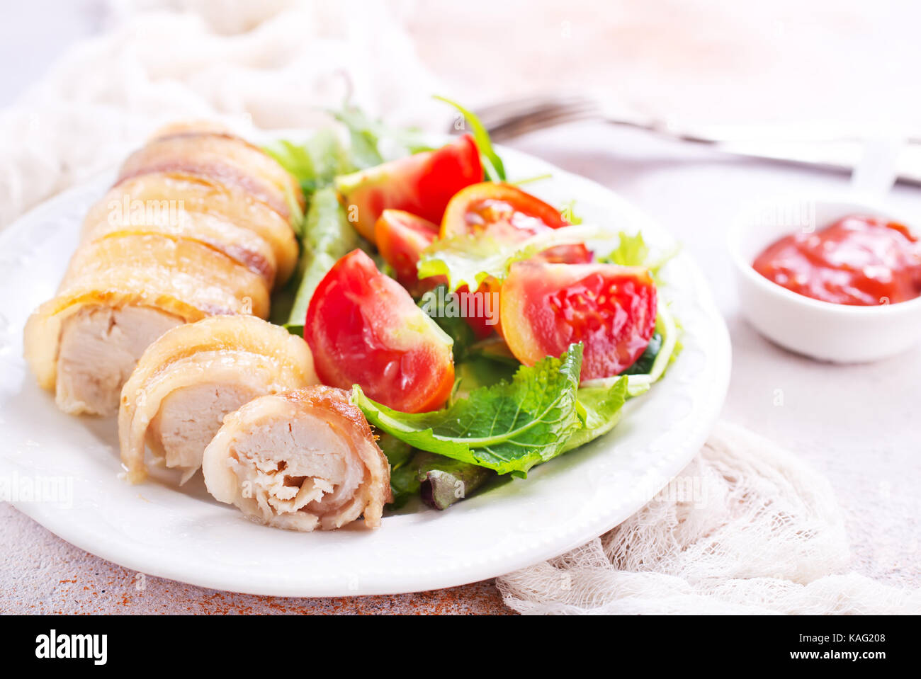 chicken roll with salad on the white plate Stock Photo - Alamy