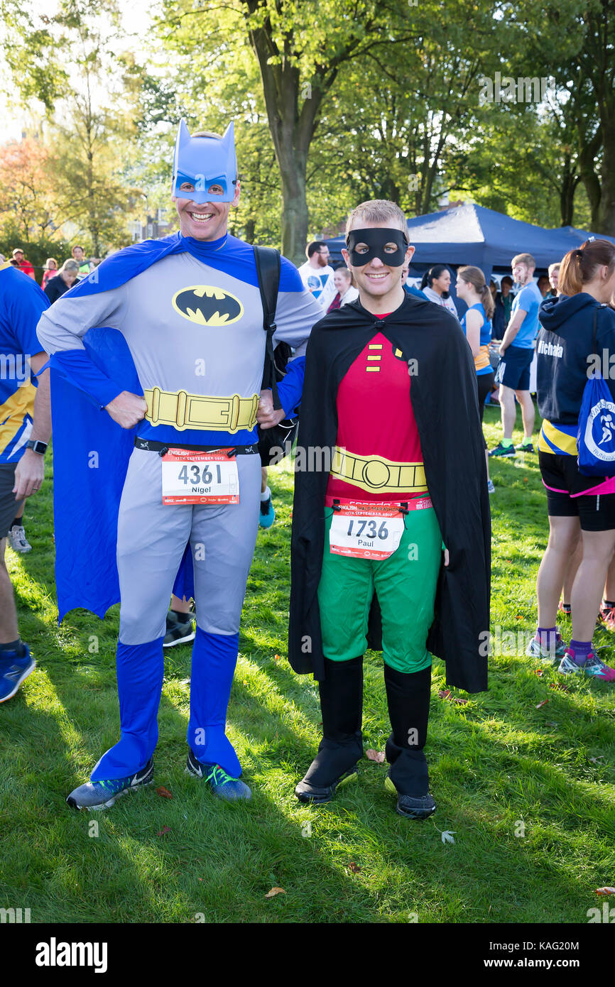 Two men dressed as Batman and Robin prepare themselves to run the ...