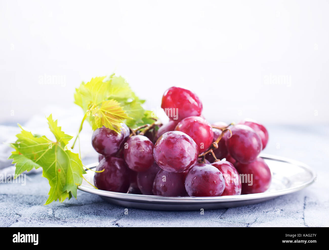fresh grape on plate and on a table Stock Photo - Alamy