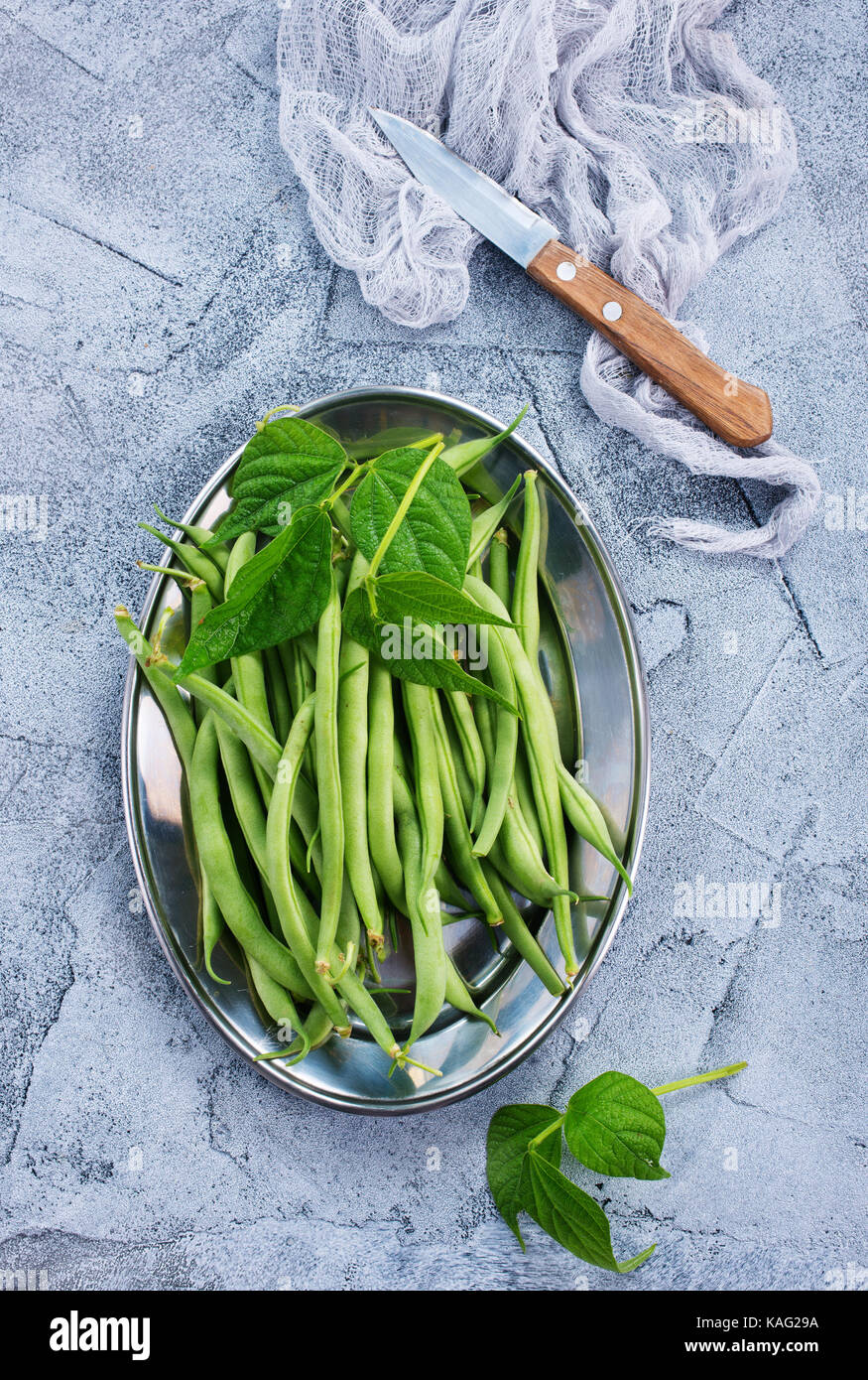 green beans on metal plate and on a table Stock Photo - Alamy