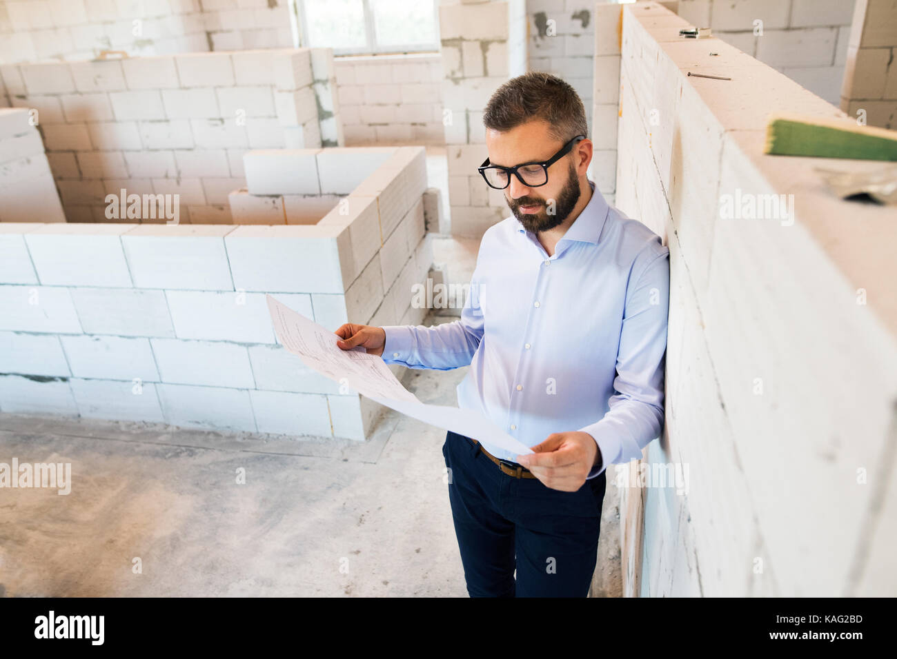 Architect or home owner at the construction site Stock Photo - Alamy