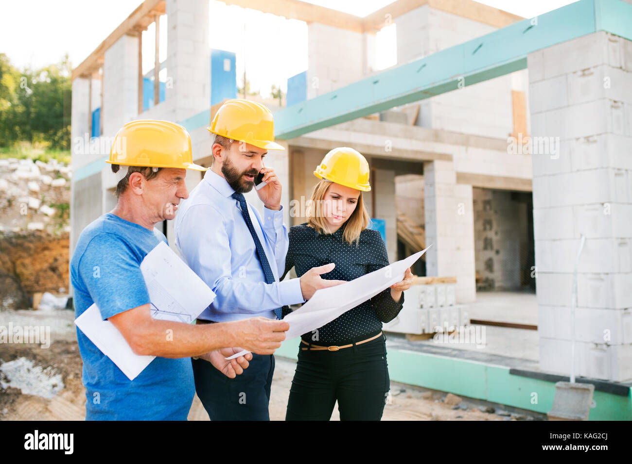 Architects and worker at the construction site Stock Photo - Alamy