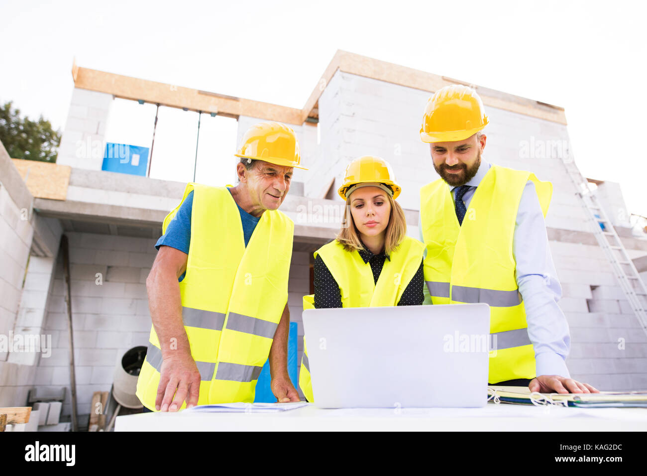 Architects and worker at the construction site Stock Photo - Alamy