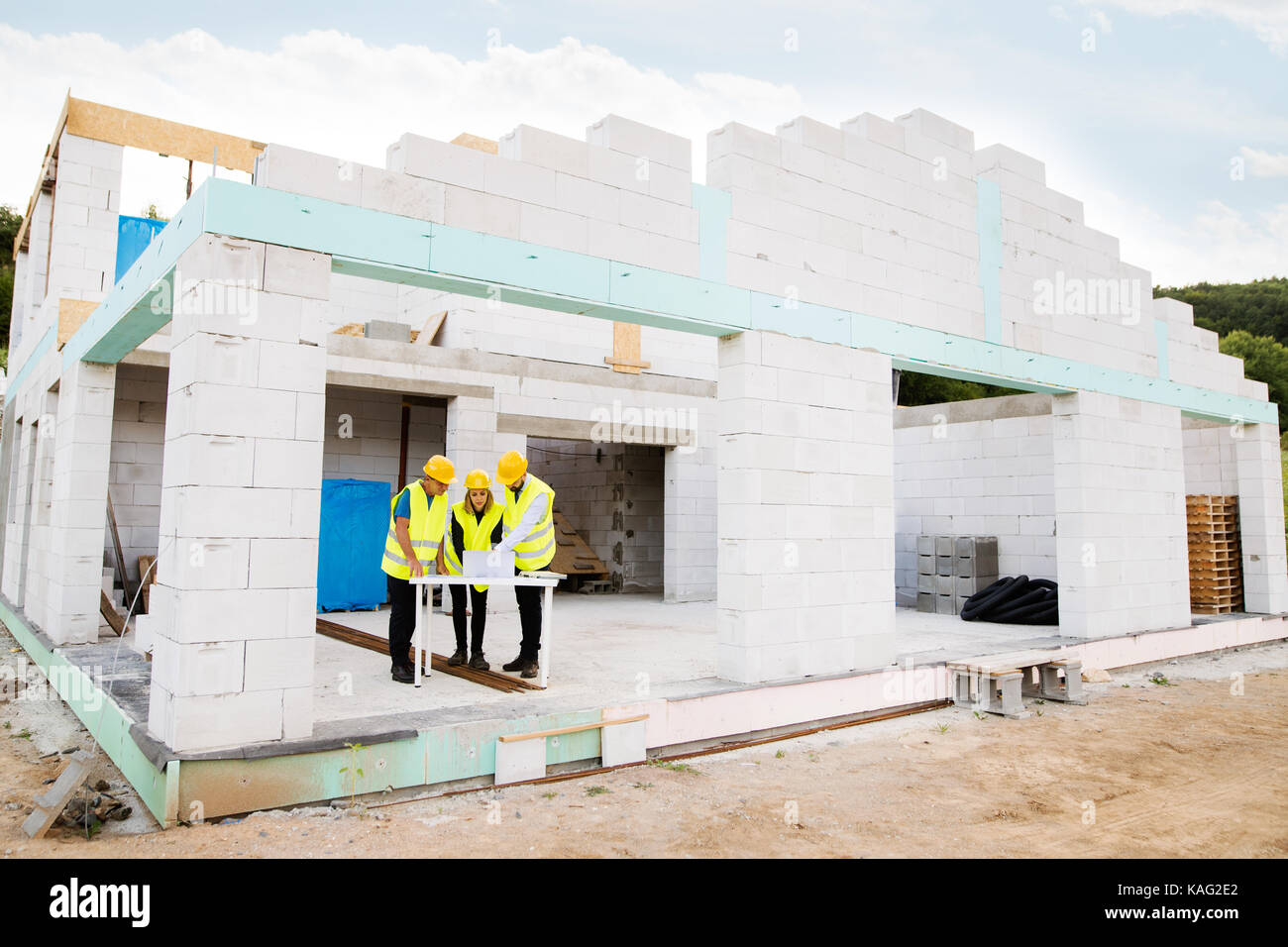 Architects and worker at the construction site Stock Photo - Alamy