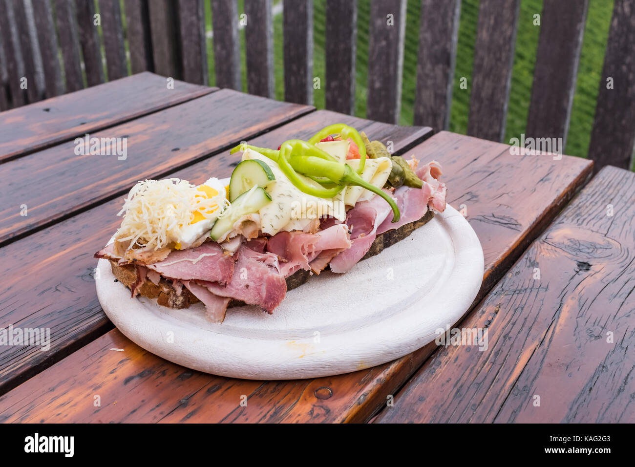 Traditional bread with lots of cold cuts on wooden table on south ...