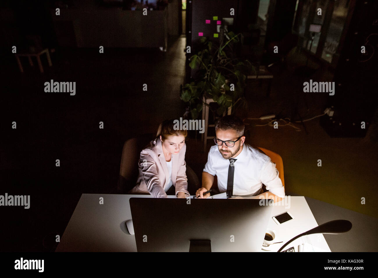Businesspeople in the office at night working late Stock Photo - Alamy