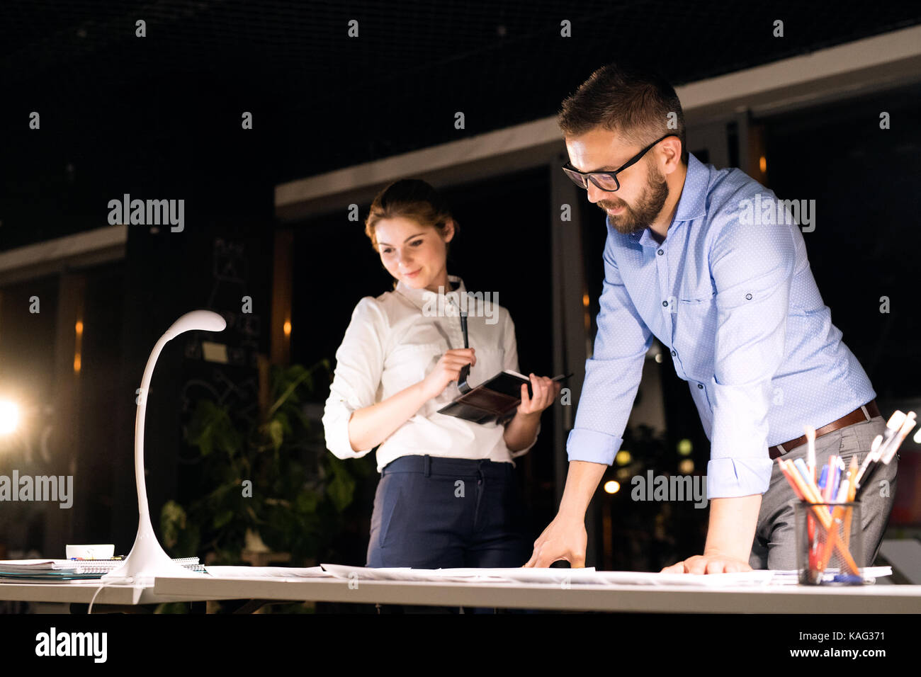 Businesspeople in the office at night working late Stock Photo - Alamy